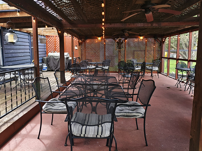 Summer evenings find their perfect expression on this screened patio, where gentle breezes complement every bite and fireflies provide nature's dinner theater.