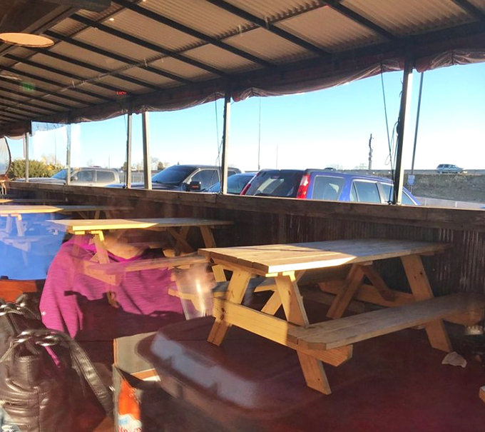 The covered patio offers a more casual setting, where picnic tables invite you to roll up your sleeves and get serious about your BBQ feast.