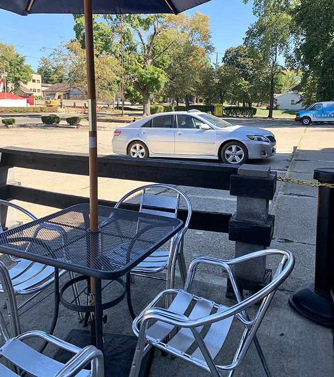 The humble patio where summer evenings stretch like lazy cats. Simple metal furniture that's hosted countless happy hours and heartfelt conversations.