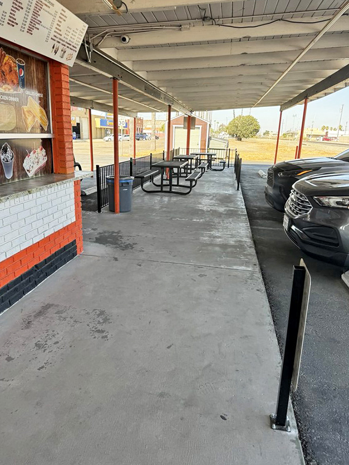 Outdoor dining California-style: simple metal tables under an open sky, where the only dress code is "hungry" and everyone's welcome.