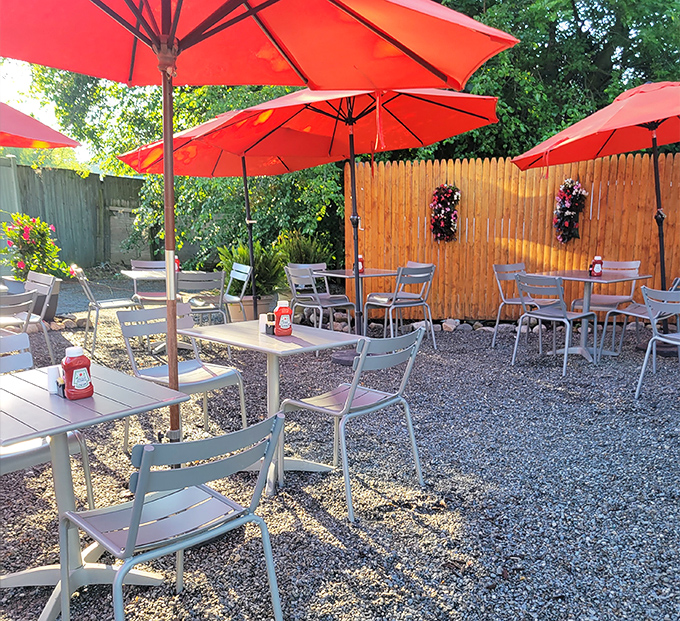 Ida's outdoor patio&mdash;where breakfast meets fresh air under cheerful red umbrellas, proving pancakes taste even better with vitamin D.