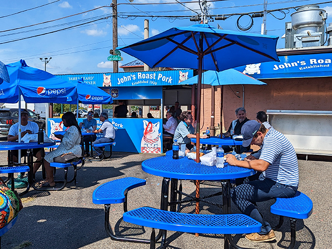 The outdoor seating area transforms a parking lot into Philadelphia's most delicious picnic spot, where every blue table holds treasure.