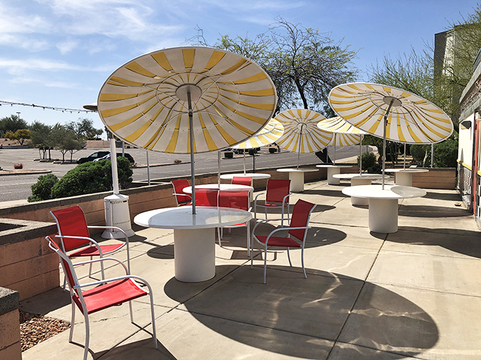 Desert dining with style. Yellow-striped umbrellas create oases of shade where diners can enjoy Mesa mornings without melting.