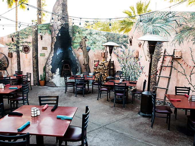 Outdoor dining that captures desert magic. Those painted walls and string lights transform an Arizona evening into something straight out of a dream.