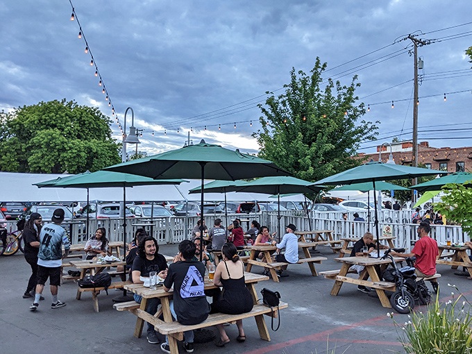 Outdoor seating under string lights where summer evenings stretch like good mozzarella. The picnic tables say "stay awhile" in the universal language of comfort.