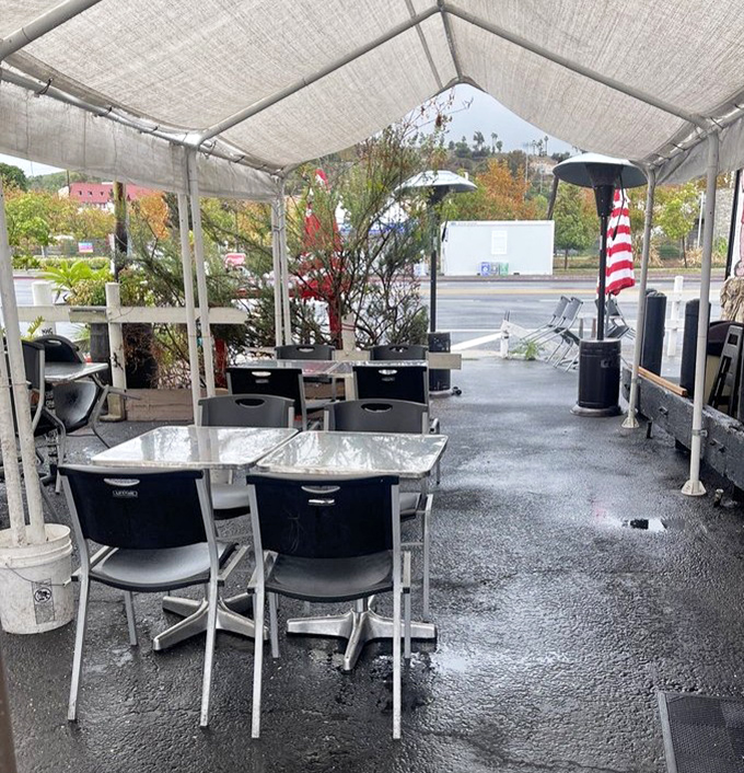 The outdoor seating area offers a moment of calm before the flavor storm that awaits inside, complete with patriotic touches.