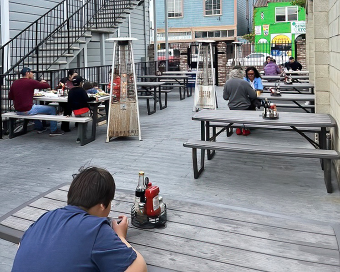 The outdoor seating area&mdash;where salty air enhances every bite. Those heat lamps ensure your seafood feast remains a warm experience year-round.