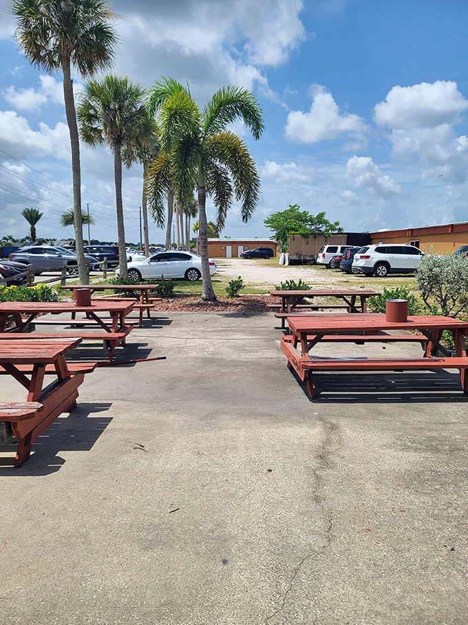 Palm trees stand sentinel over picnic tables, offering shade and tropical ambiance. This outdoor oasis provides the perfect spot for a mid-shopping refuel.