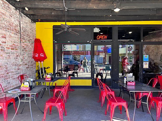 Outdoor seating with cheerful red umbrellas&mdash;because vitamin D makes everything taste better, especially Tom's legendary hot dogs.
