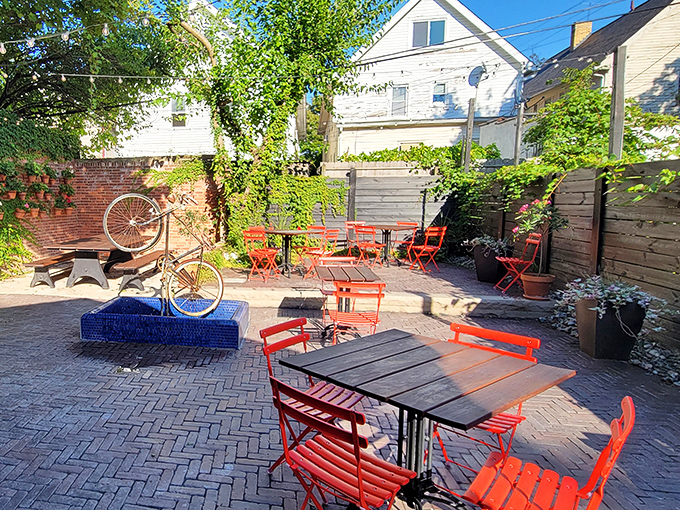 The patio's vibrant red chairs and brick pavers create an urban oasis where pizza tastes even better under Ohio's summer sky.