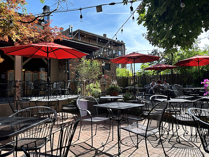 The patio offers al fresco dining under Cleveland skies, where red umbrellas stand guard over conversations that linger longer than planned.