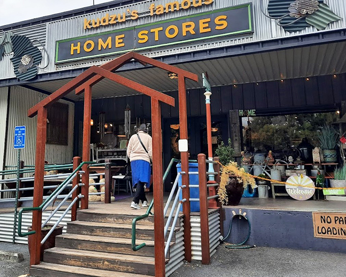 The corrugated metal entrance feels like stepping into a design-forward barn where the livestock has been replaced with vintage treasures.