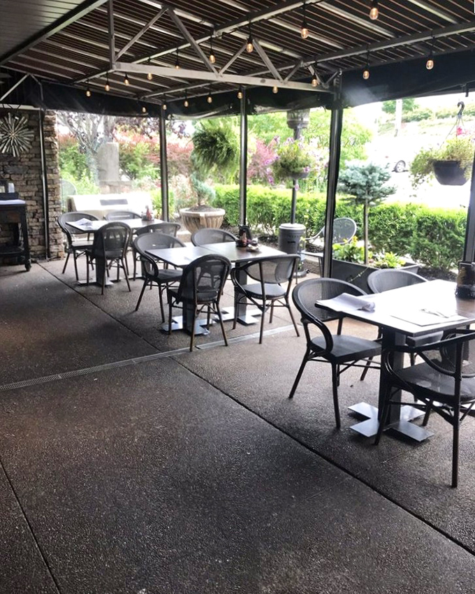The outdoor seating area offers a garden oasis for those who prefer their comfort food with a side of fresh air and people-watching.