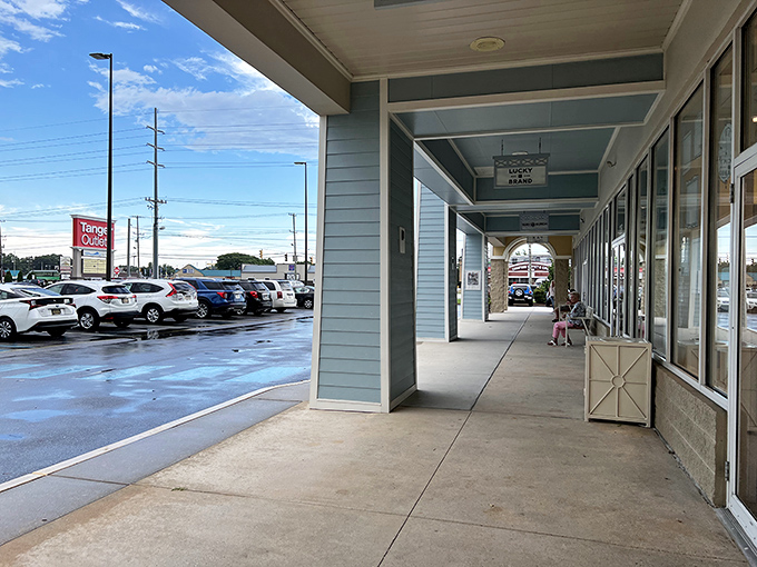 Covered walkways offer merciful shade for sun-drenched shoppers, proving that Tanger understands the delicate balance between shopping and comfort.