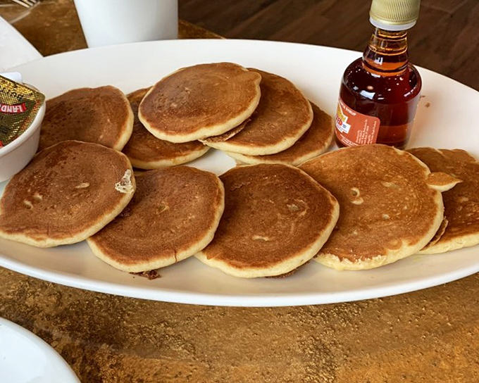 Pancakes stacked higher than your weekend to-do list, golden-brown and ready for their maple syrup waterfall moment. Breakfast of champions, indeed.