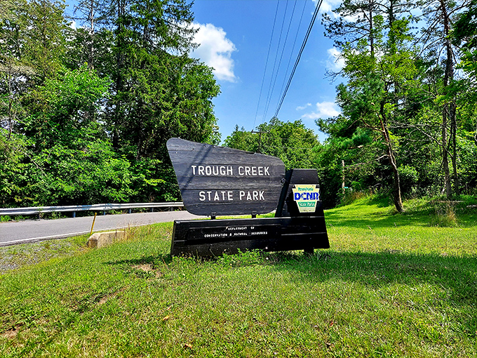 The park entrance sign welcomes visitors to a world where cell service fades but connection strengthens. The original welcome screen.
