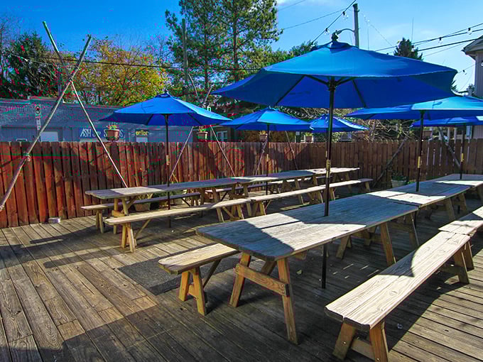 The patio—where picnic tables, blue umbrellas, and fresh air conspire to make your barbecue experience even more memorable. Dogs welcome, vegetarians tolerated.