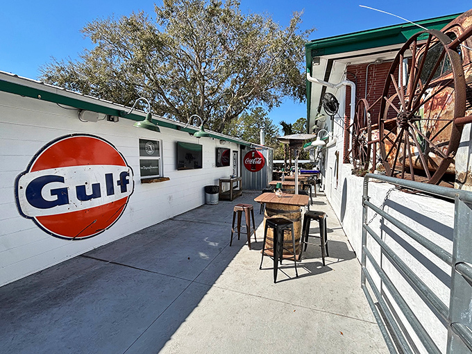 Outdoor seating with a side of nostalgia &ndash; that Gulf sign isn't just decoration, it's a reminder of road trips before GPS told us where to stop.