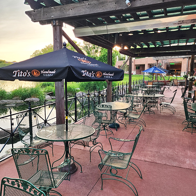 The lakeside patio at sunset offers the kind of dining view that makes you forget you're in Nebraska and not some exclusive coastal resort.