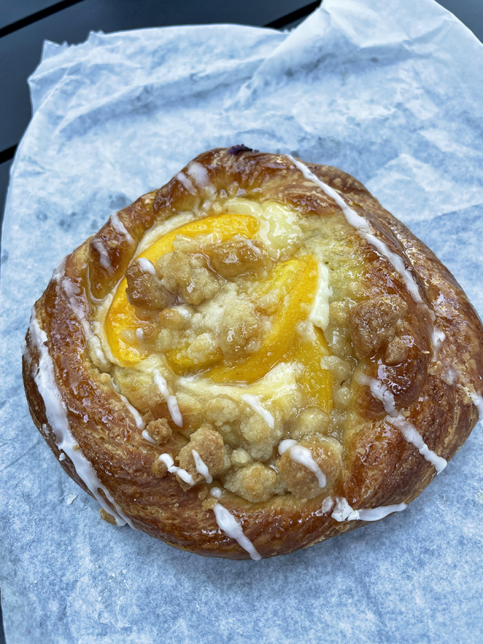 This peach danish is basically summer vacation on parchment paper&mdash;golden, buttery pastry cradling sunshine-bright fruit that makes you want to linger.