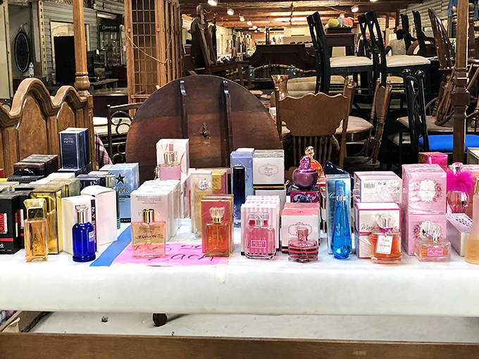 Perfume bottles stand like tiny soldiers guarding their fragrant treasures, while vintage furniture lurks in the background awaiting restoration.