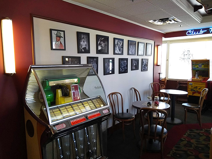 The wall of fame features icons from a simpler time, while the vintage jukebox stands ready to provide the soundtrack for your comfort food symphony.