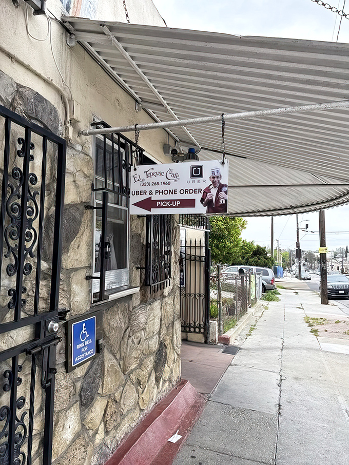 The side entrance offers a glimpse into the restaurant's practical evolution&mdash;modern convenience meeting decades-old tradition at the pickup window.