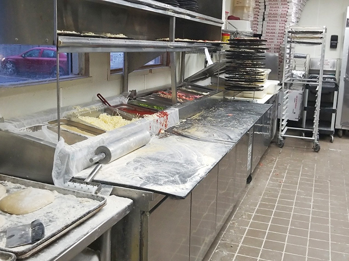 Behind the scenes: where pizza magic happens with flour, sauce, and pure Michigan dedication. 