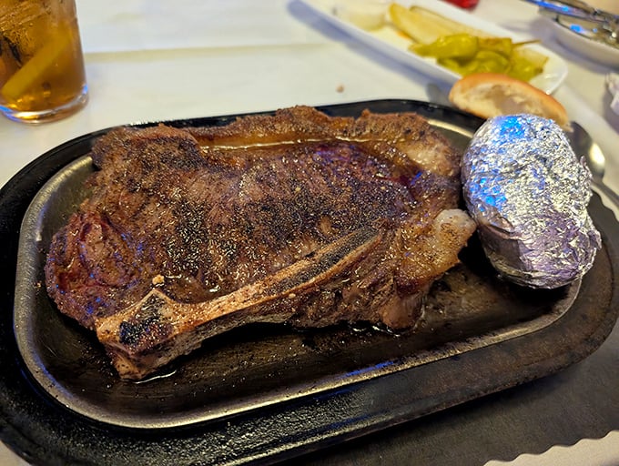 This pork chop has been cooked by someone who respects meat&mdash;perfectly seared, juicy inside, with a baked potato standing by.