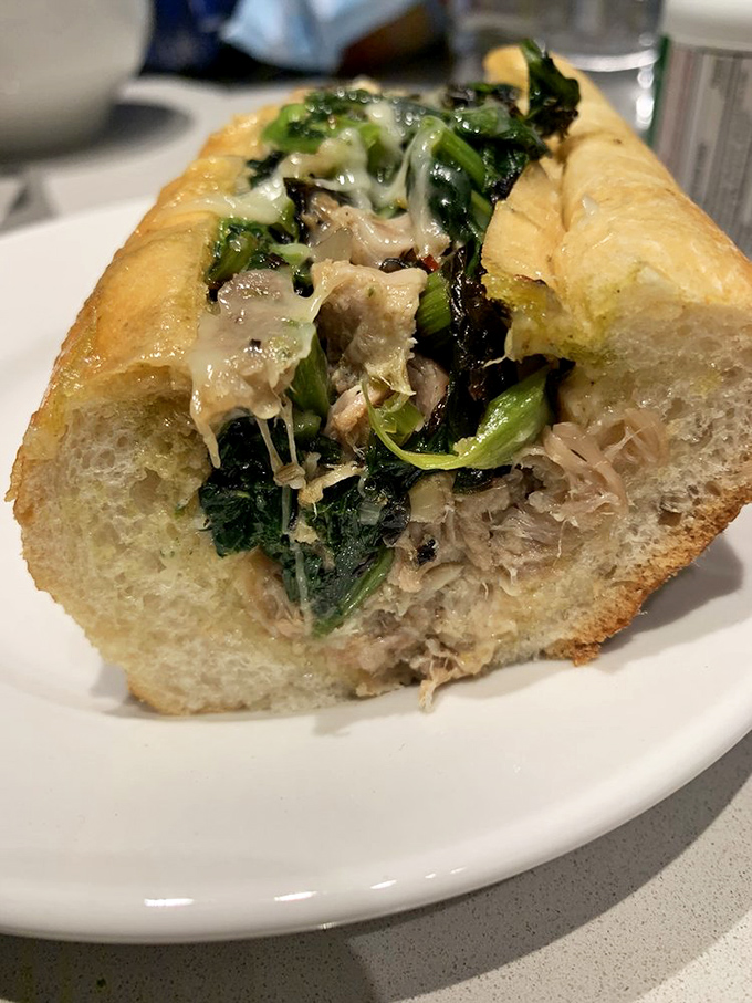 When pork and greens meet on a roll, magic happens. This sandwich doesn't just satisfy hunger&mdash;it creates food memories that haunt you pleasantly.