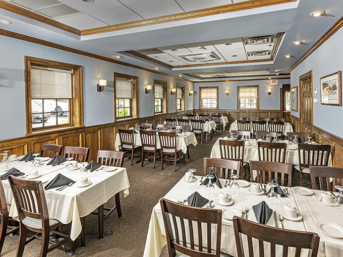 The formal dining room stands ready for celebrations, its white tablecloths and warm wood tones promising an experience several notches above everyday dining.