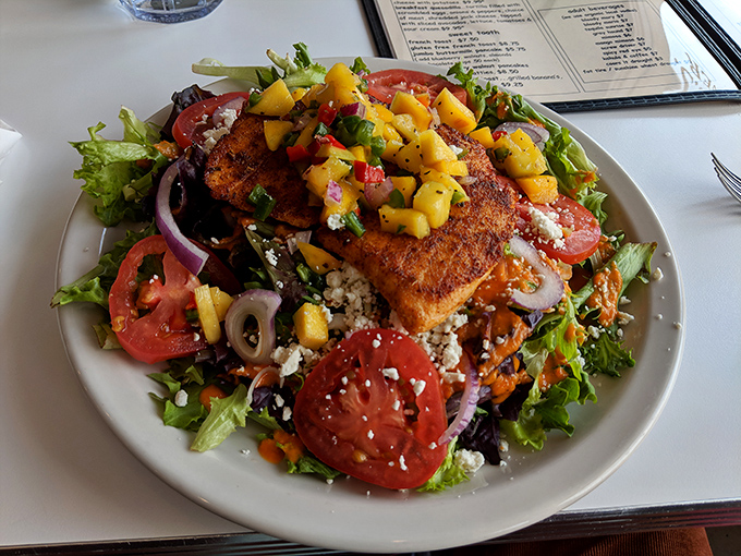 Not all heroes wear capes—some wear mango salsa and sit atop beds of greens, proving salads at diners can be both virtuous and delicious.