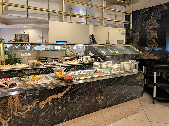 The salad bar gleams with marble elegance, offering fresh ingredients behind spotless glass. A buffet that elevates the self-serve experience.