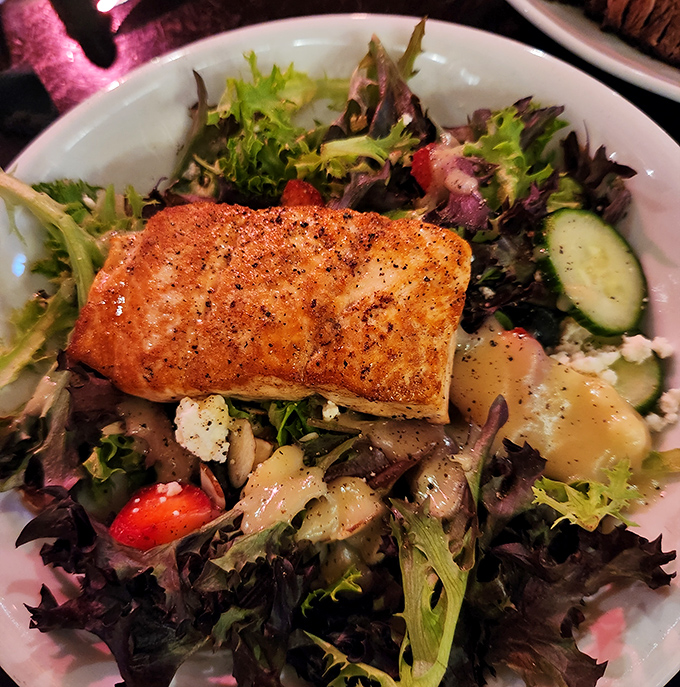 A perfectly seared salmon crowns a vibrant salad &ndash; proof that this steakhouse respects the ocean's bounty just as much as its land-based offerings.
