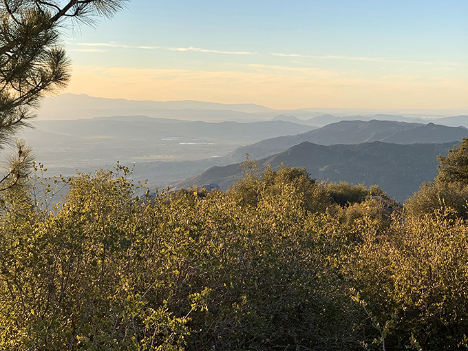 The layered mountains fade into misty blue distance&mdash;each ridge a different shade, as if the landscape is showing off its perfect ombr&eacute; technique.