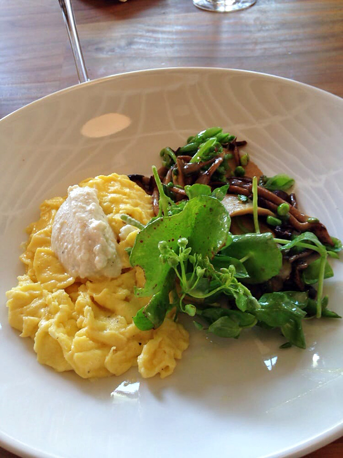 Scrambled eggs that look like clouds next to mushrooms that look like they were foraged by woodland elves. Breakfast perfection.