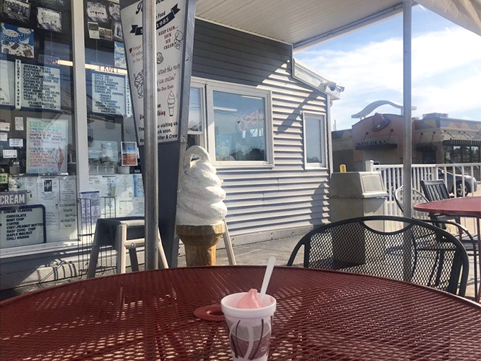 The outdoor seating area&mdash;where ice cream melts slightly slower than time itself. That towering soft serve cone in the background isn't just decoration.
