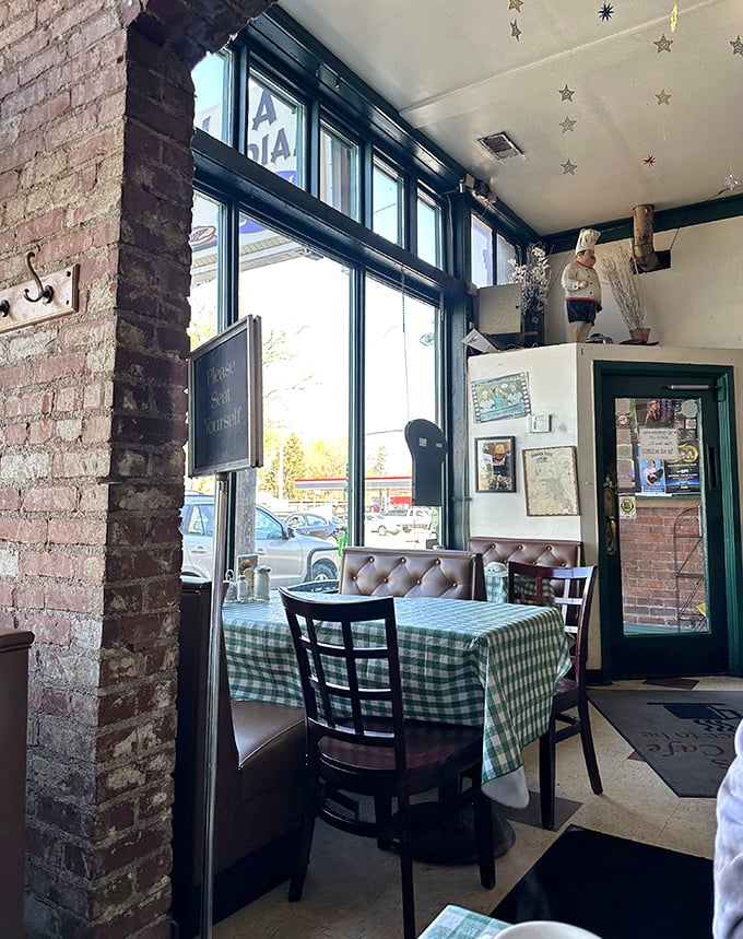 Sunlight streams through those classic green-trimmed windows, illuminating a corner table where memories are made over plates of comfort food and endless coffee refills.