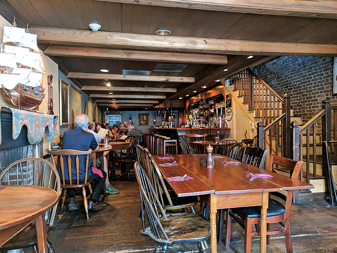 Tables arranged for both intimate conversations and boisterous gatherings. The ship models stand guard, ensuring your meal is seaworthy and your spirits remain high. 