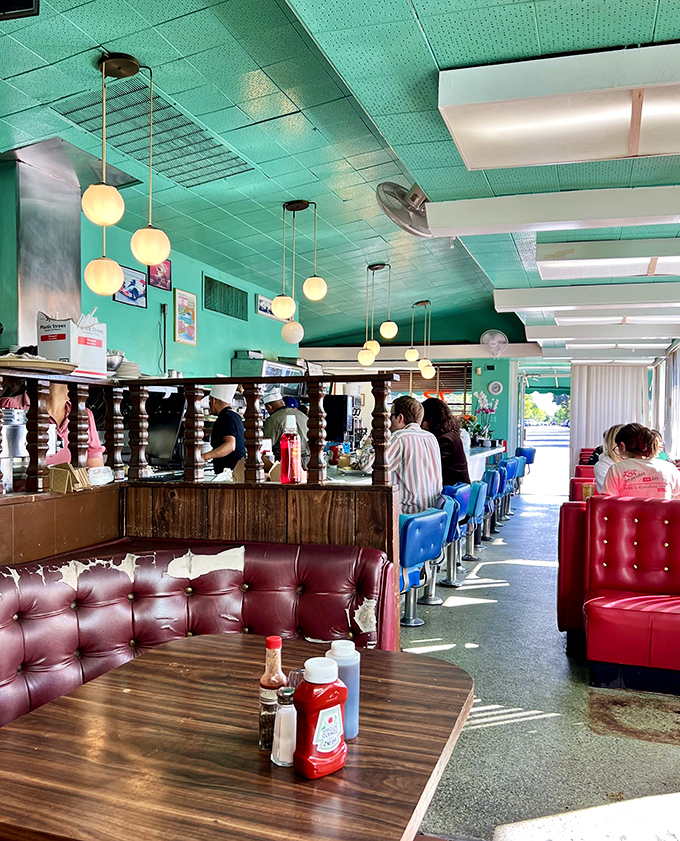 Diner perfection under turquoise skies. Those pendant lights have witnessed thousands of coffee refills and "just one more bite" moments since Kennedy was president.