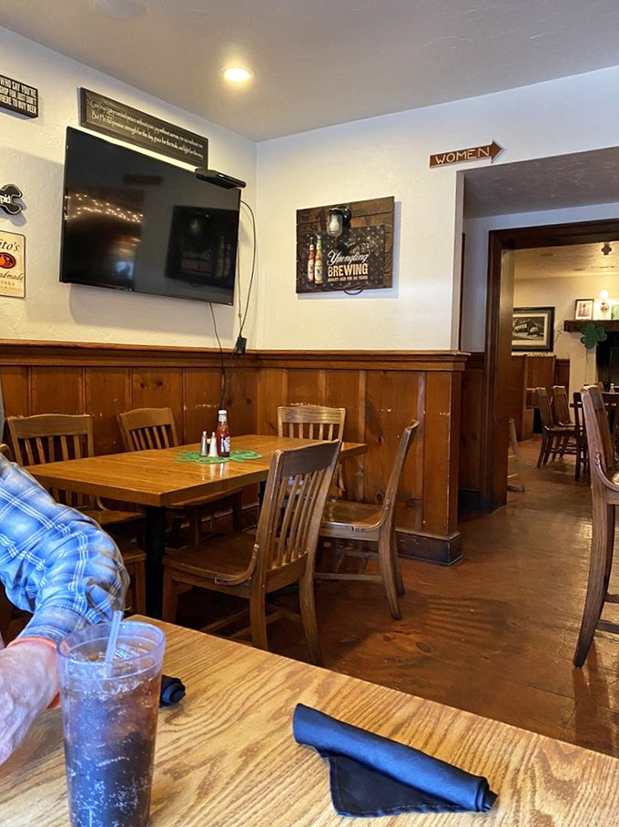 Cozy dining nooks with warm wood paneling create intimate spaces for enjoying hearty meals, while still feeling part of the pub's convivial atmosphere.