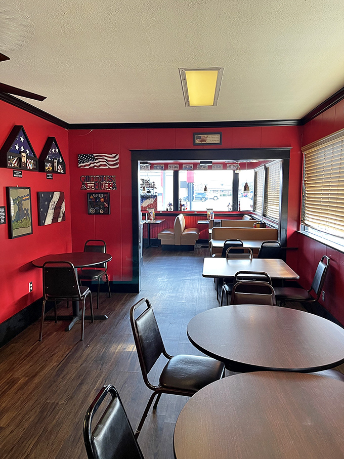 Red walls showcase American flags and vintage signs, creating a dining room that celebrates straightforward patriotic comfort.