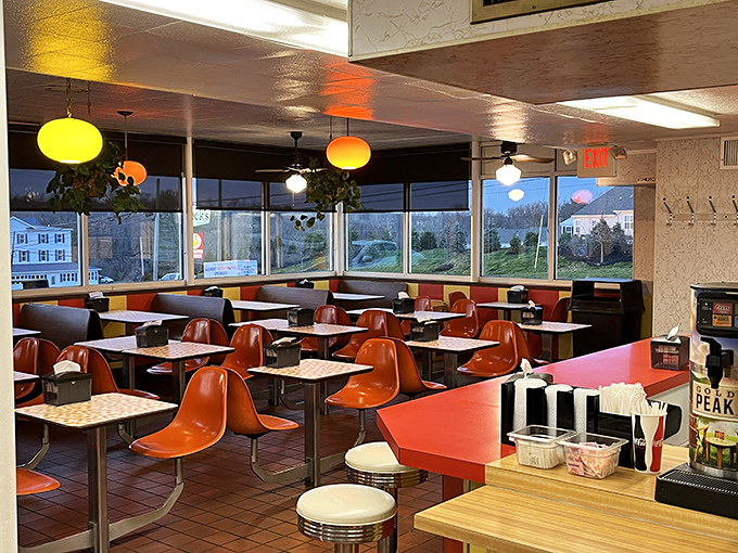 Evening light streams through windows, casting a golden glow on empty chairs waiting for tomorrow's stories and conversations.