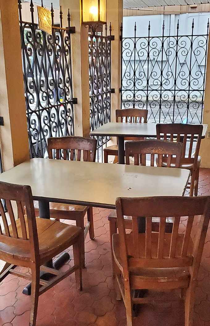 The seating area with decorative ironwork offers a touch of unexpected charm, like finding out your no-nonsense uncle secretly writes poetry.