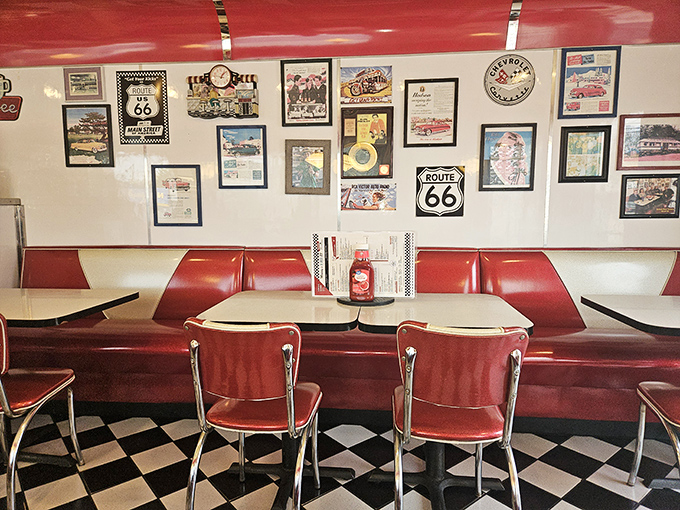 Route 66 memorabilia watches over diners like patron saints of road trips. These red booths have witnessed countless first dates, family celebrations, and traveling tales.