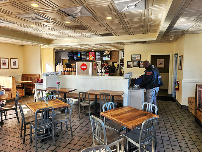 Clean lines, pressed tin ceilings, and natural light create the perfect backdrop for the serious business of burger enjoyment.