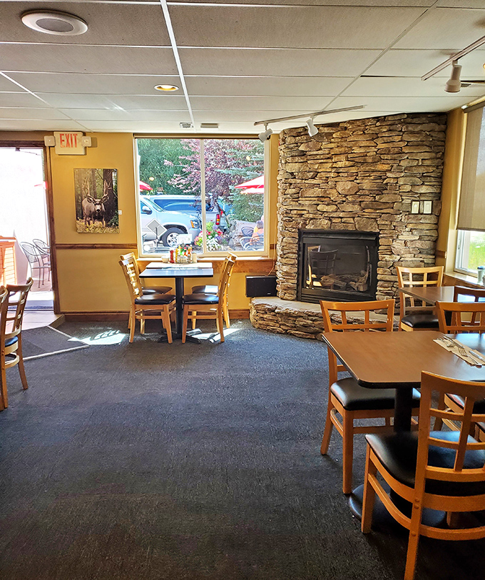 That stone fireplace isn't just decoration&mdash;it's the soul of this cozy corner where window seats offer views of Kamas life passing by.