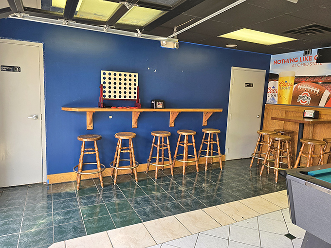 The blue wall and wooden stools create the perfect perch for pizza contemplation&mdash;or for waiting out the "five more minutes" your order needs.