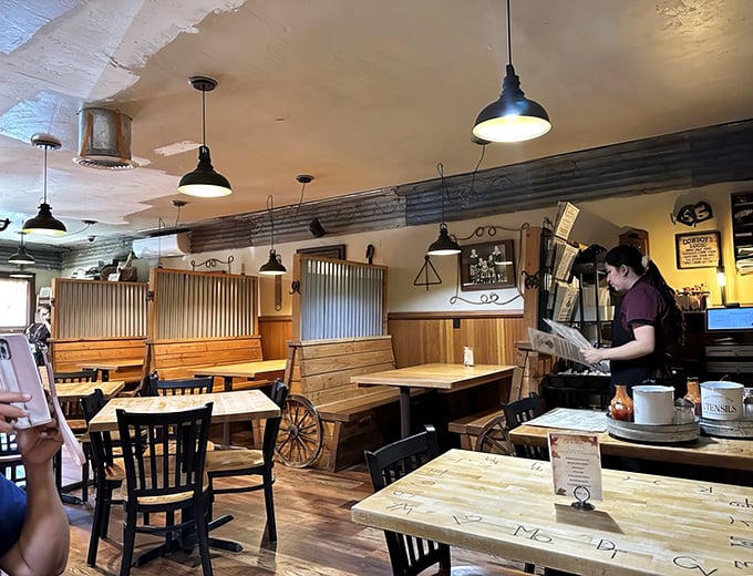 Rustic charm meets practical comfort in a dining space where wagon wheels and wooden booths create the perfect backdrop for memorable mountain meals.