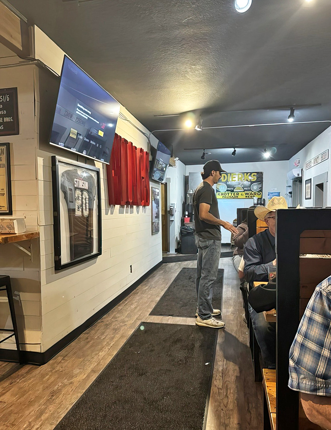 The narrow hallway that leads to flavor town. Sports memorabilia and simple décor keep the focus where it belongs—on the food.